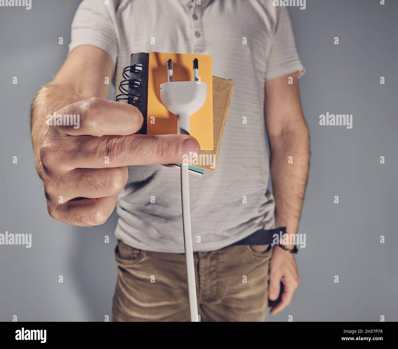 Businessman holding electric plug hi-res stock photography and images ...