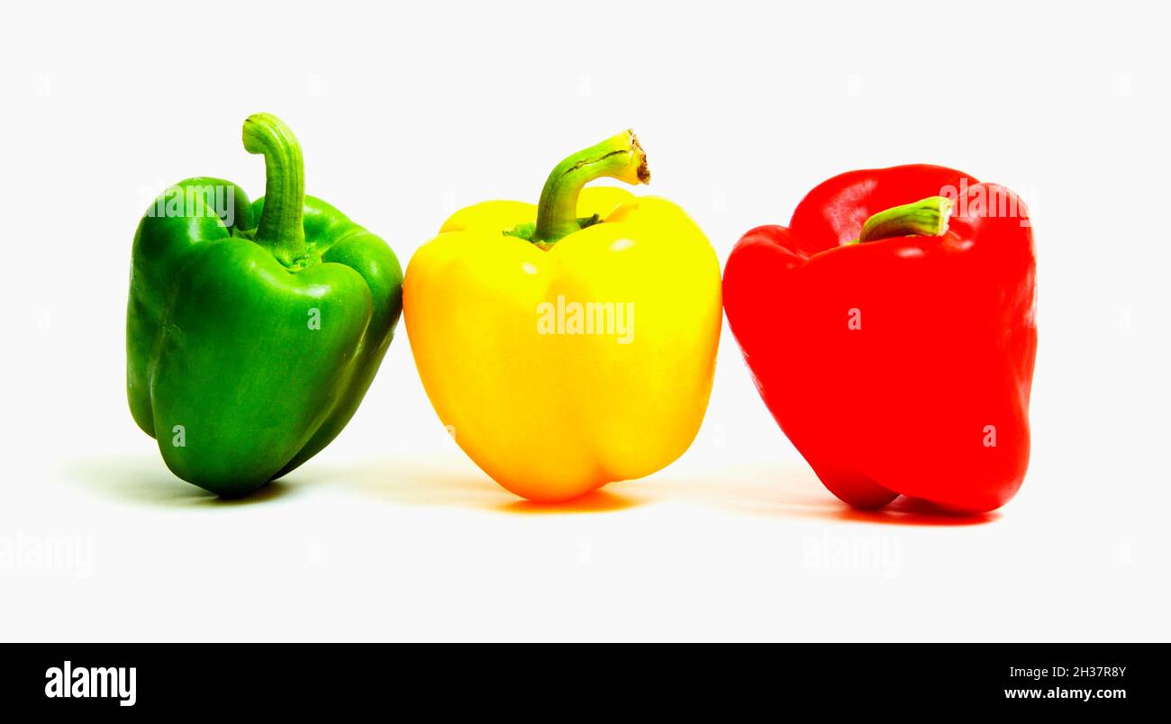 Colored peppers on a white background Stock Photo - Alamy