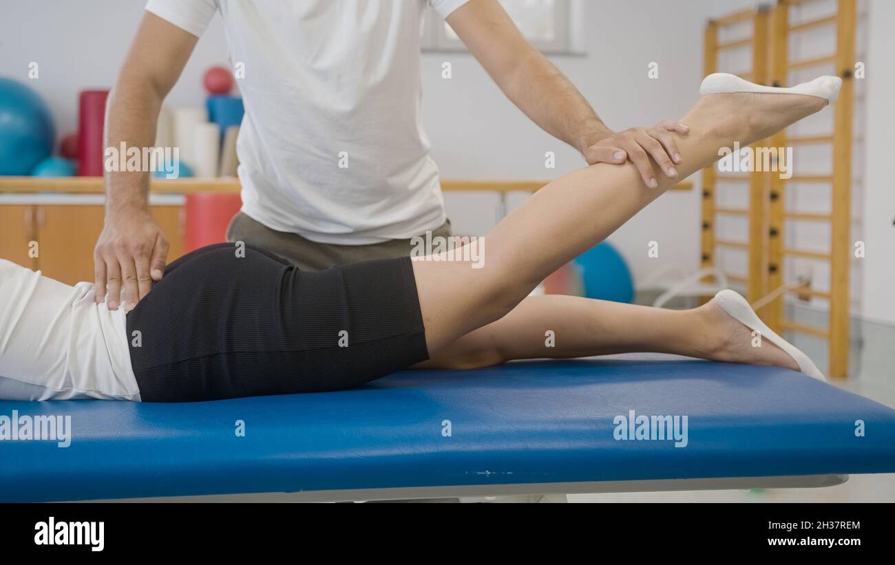 Physiotherapist giving an exercises treatment, to the female patient ...