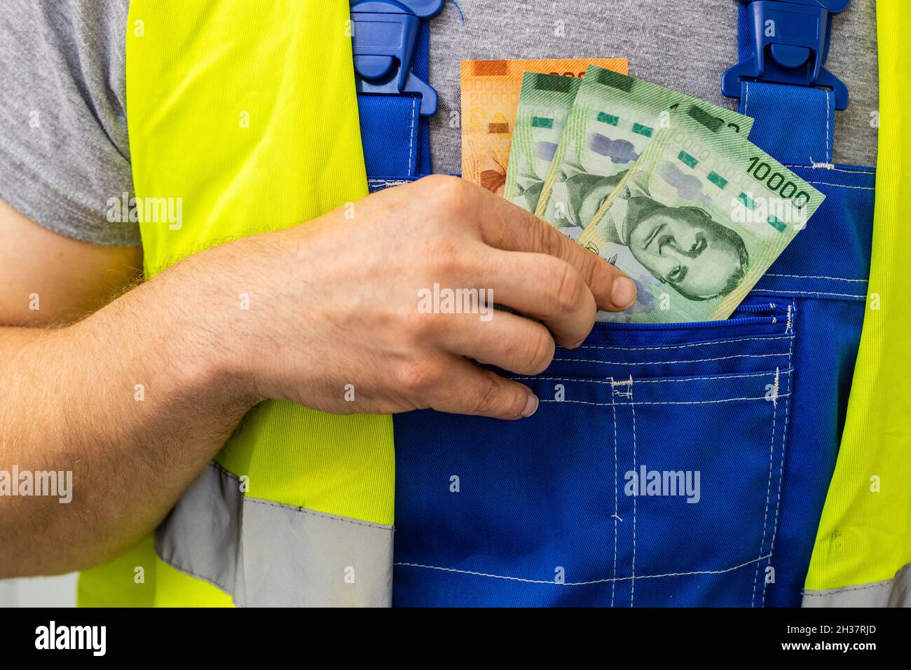 Worker counting his earnings, Costa Rica money, Concept of wages and ...
