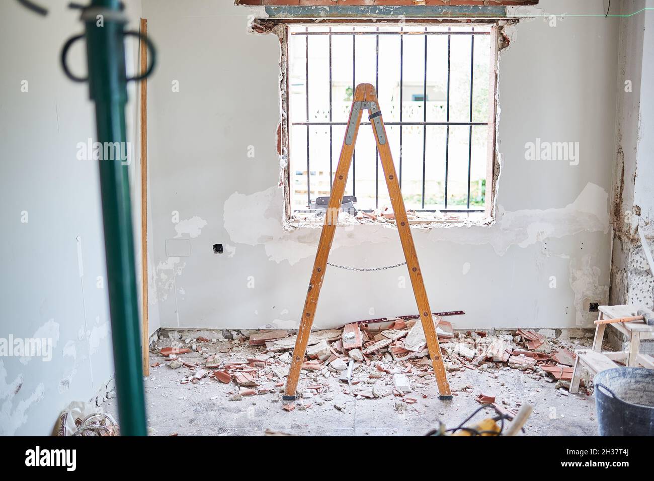 Interior of a house under renovation with rubble on the floor and a ...