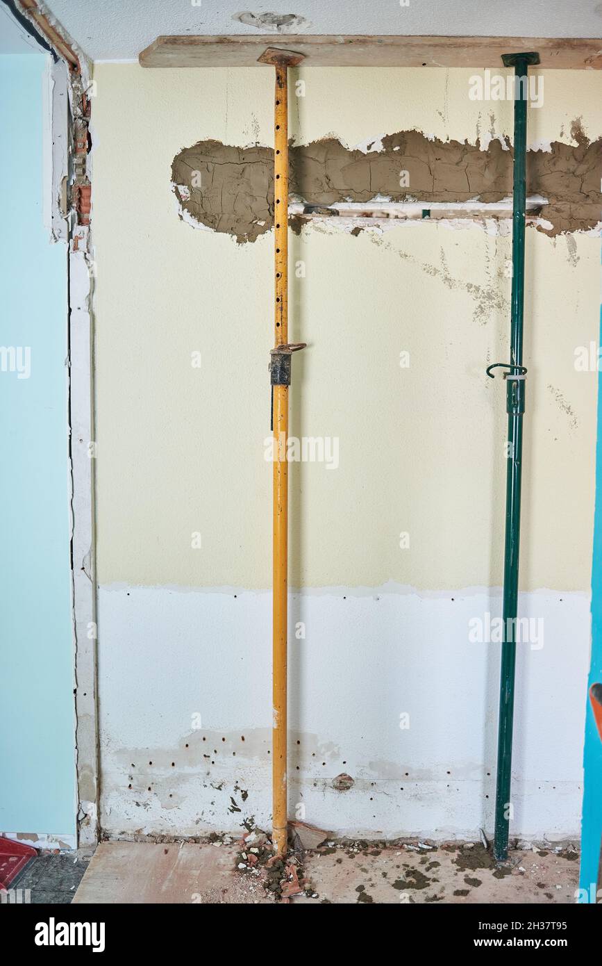 Construction struts support the roof of a house under construction ...