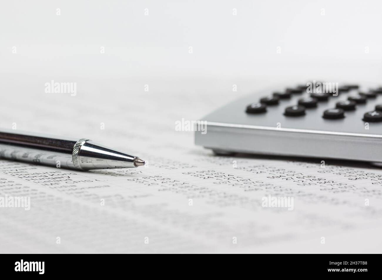 Financial accounting Pen and calculator on balance sheets Stock Photo ...