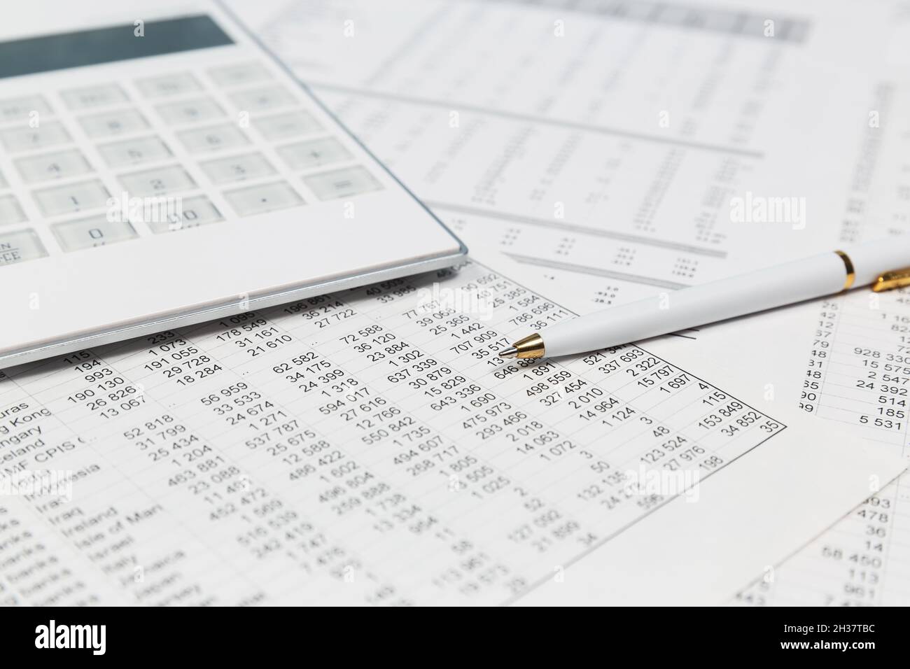 Financial accounting Pen and calculator on balance sheets Stock Photo ...