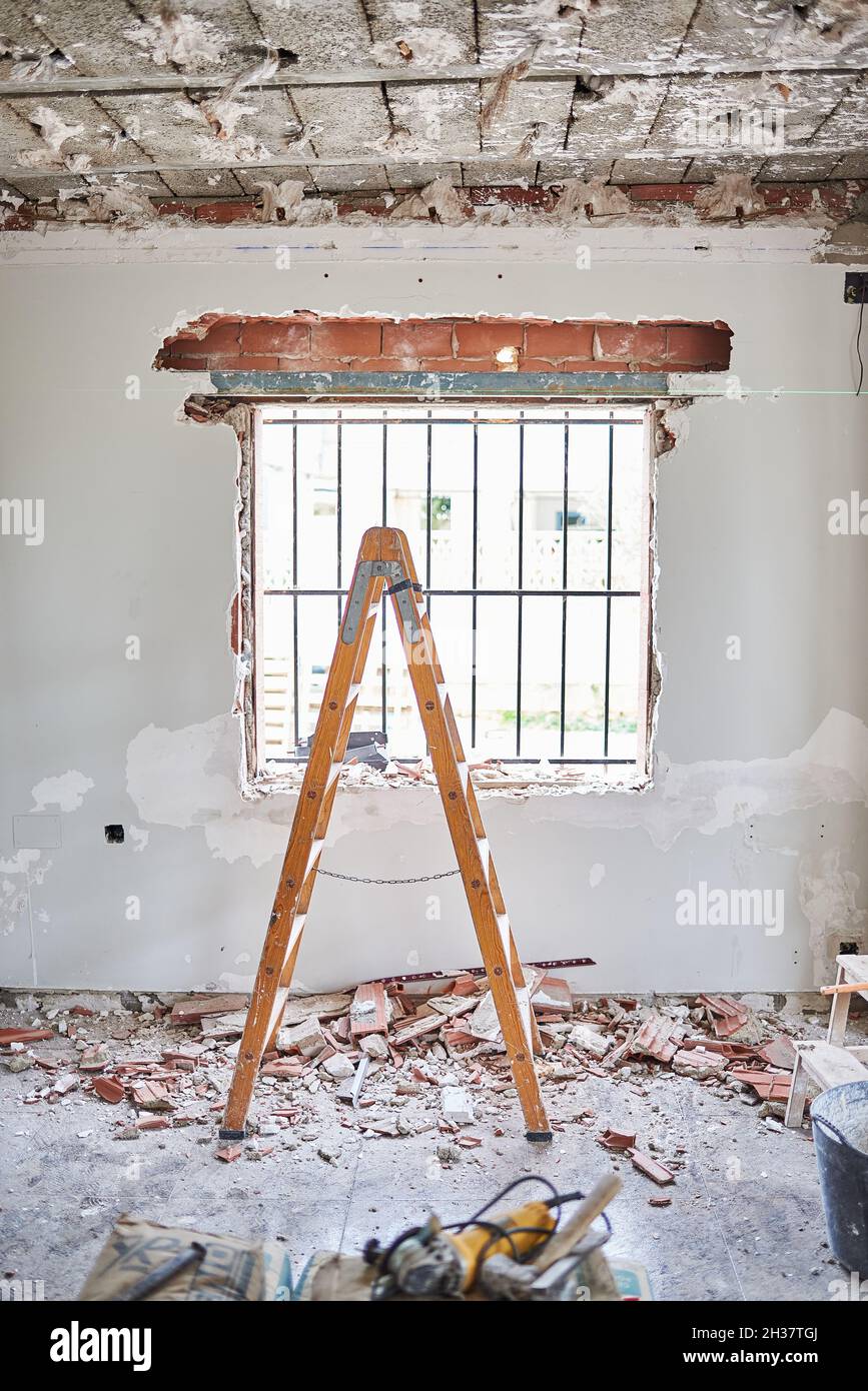 Interior of a house under renovation with rubble on the floor and a ...