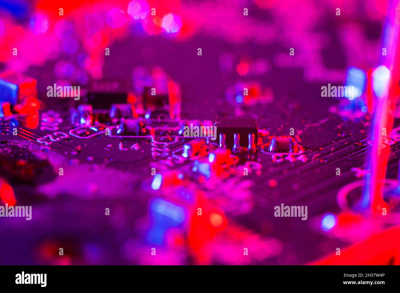 Old electronic circuit board close up in macro photography, red ...