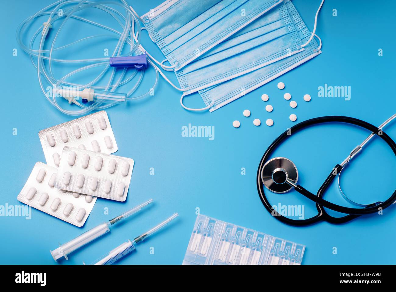 Top view doctor table with medical stethoscope, syringes, pills ...