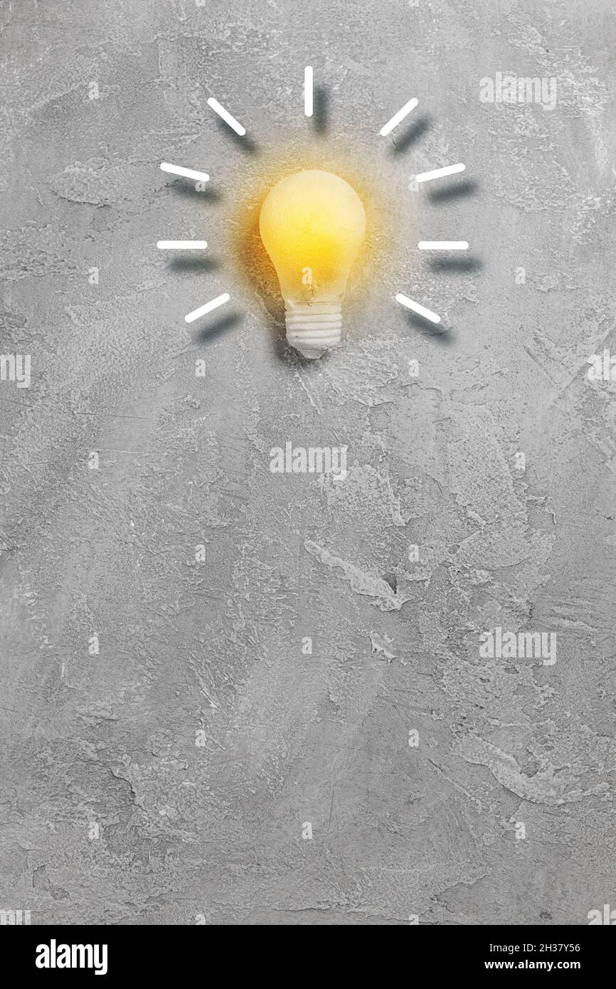 Attention glowing light bulb and text on gray concrete background ...