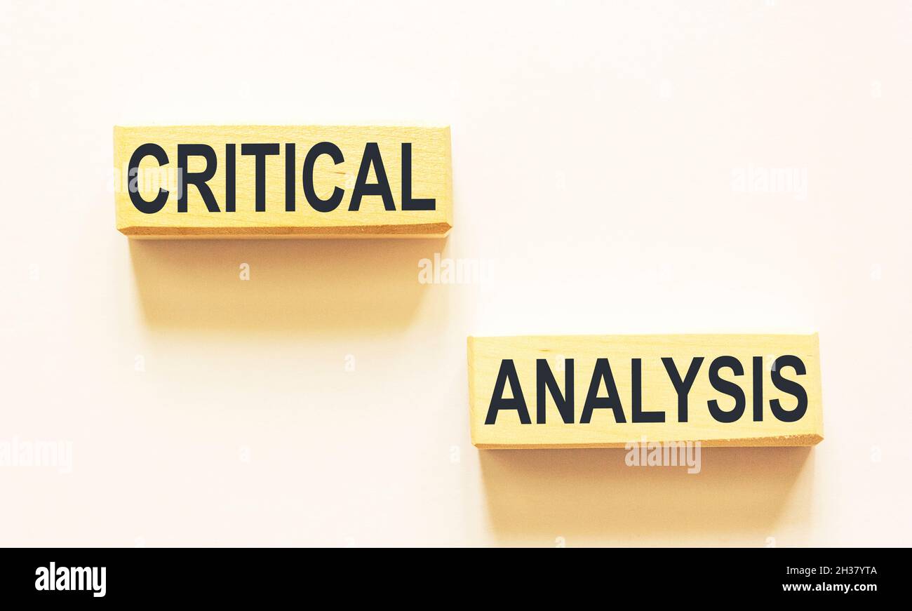 critical analysis - isolated text on wooden blocks and white background ...