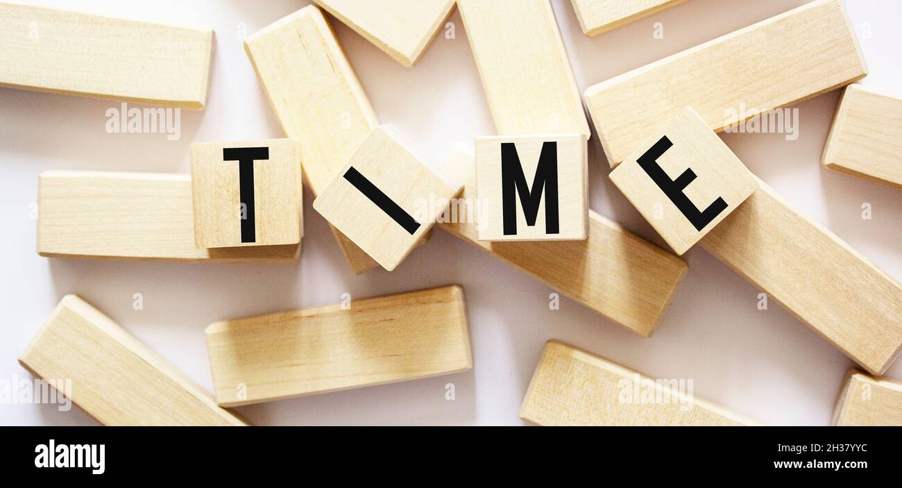 TIME, text is written on wooden cubes and white background Stock Photo ...