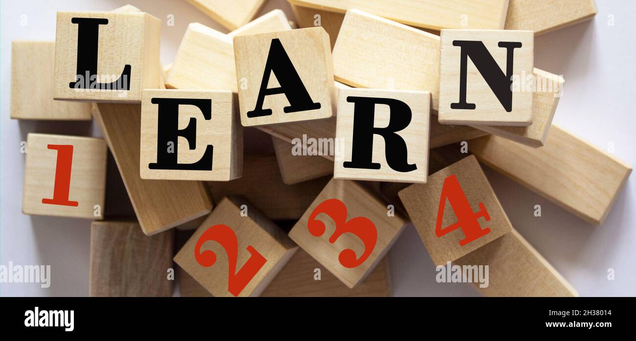 The word learn and 1 2 3 4 written on wooden cubes and a white ...