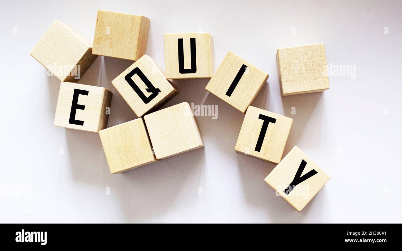 The word EQUITY is composed of building blocks on a white background ...