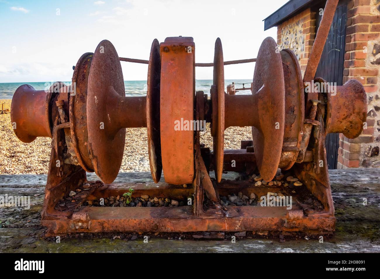 Rusty old boat winch on Brighton beach Stock Photo - Alamy