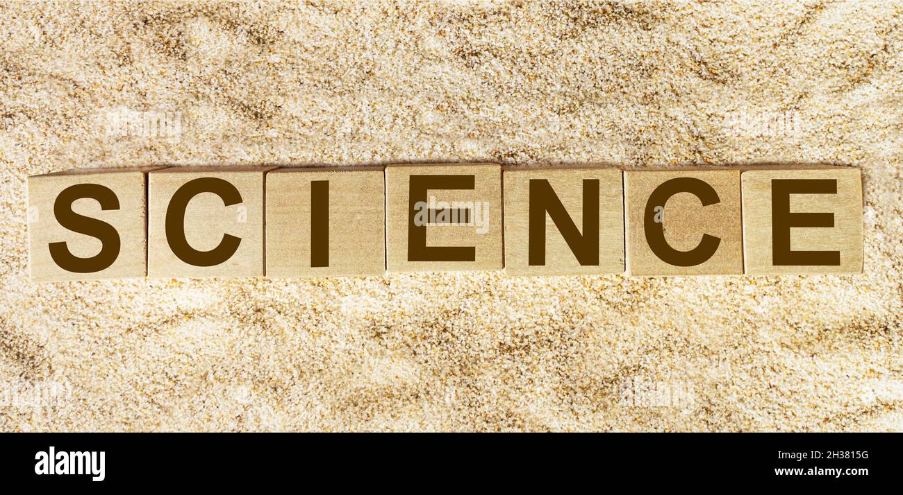 Science word written on wooden block and sand background for your ...