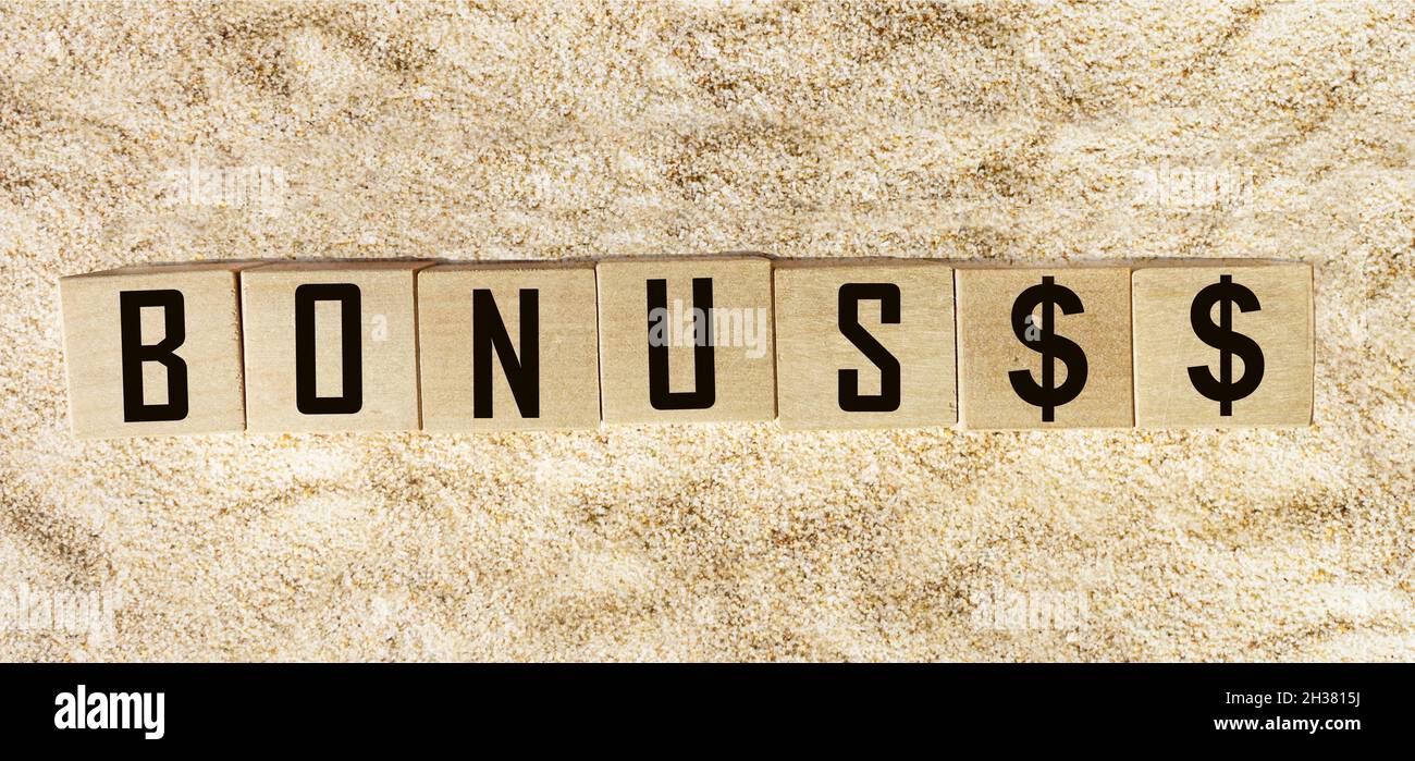 BONUS word made from building blocks on sandy background Stock Photo ...