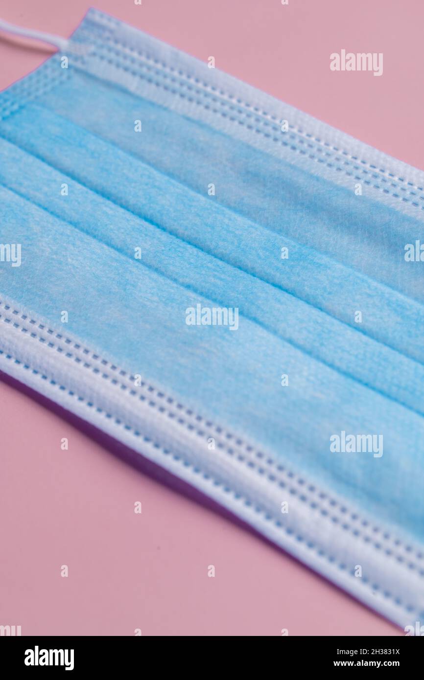 Blue face mask on a pink background. Covid 19 face mask. Corona virus ...