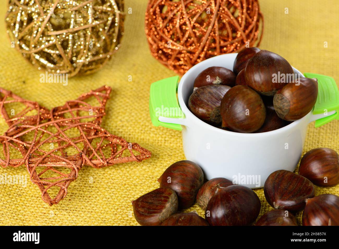 portuguese nuts in ceramic container over yellow jute and with ...