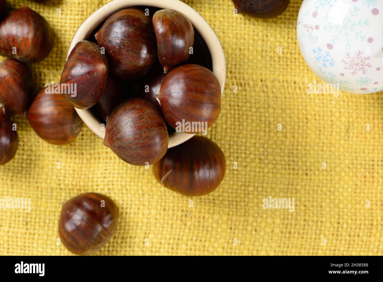 portuguese nuts in ceramic container on table with yellow jute Stock ...