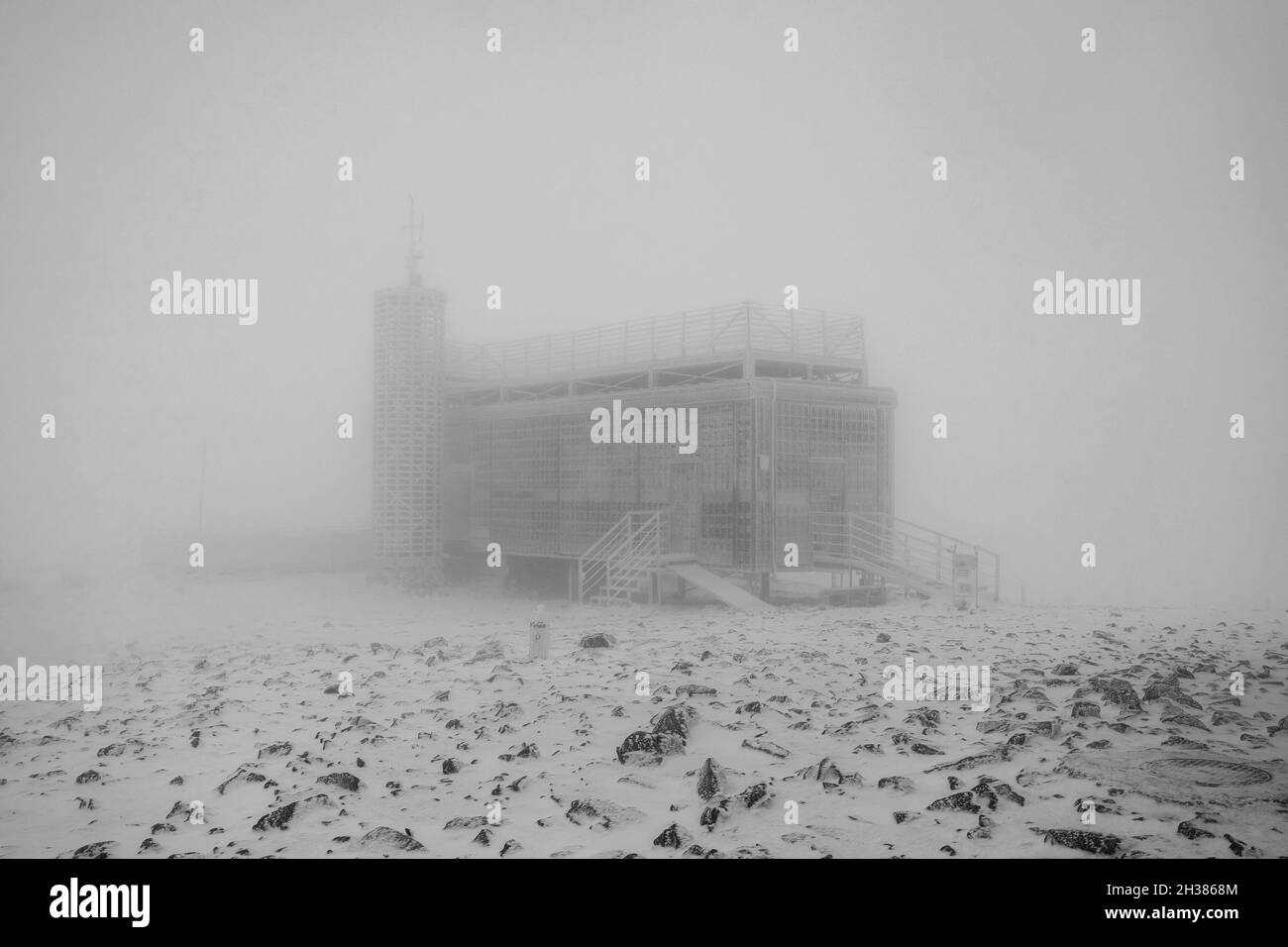 Lonely snow-covered building in the fog. Black and white Stock Photo ...