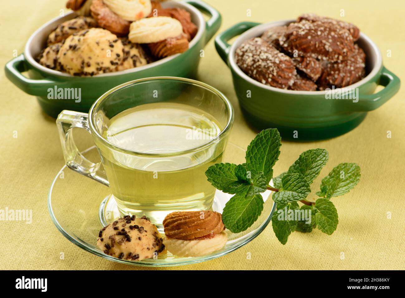 mint tea in transparent cup with sweet cookies around Stock Photo - Alamy