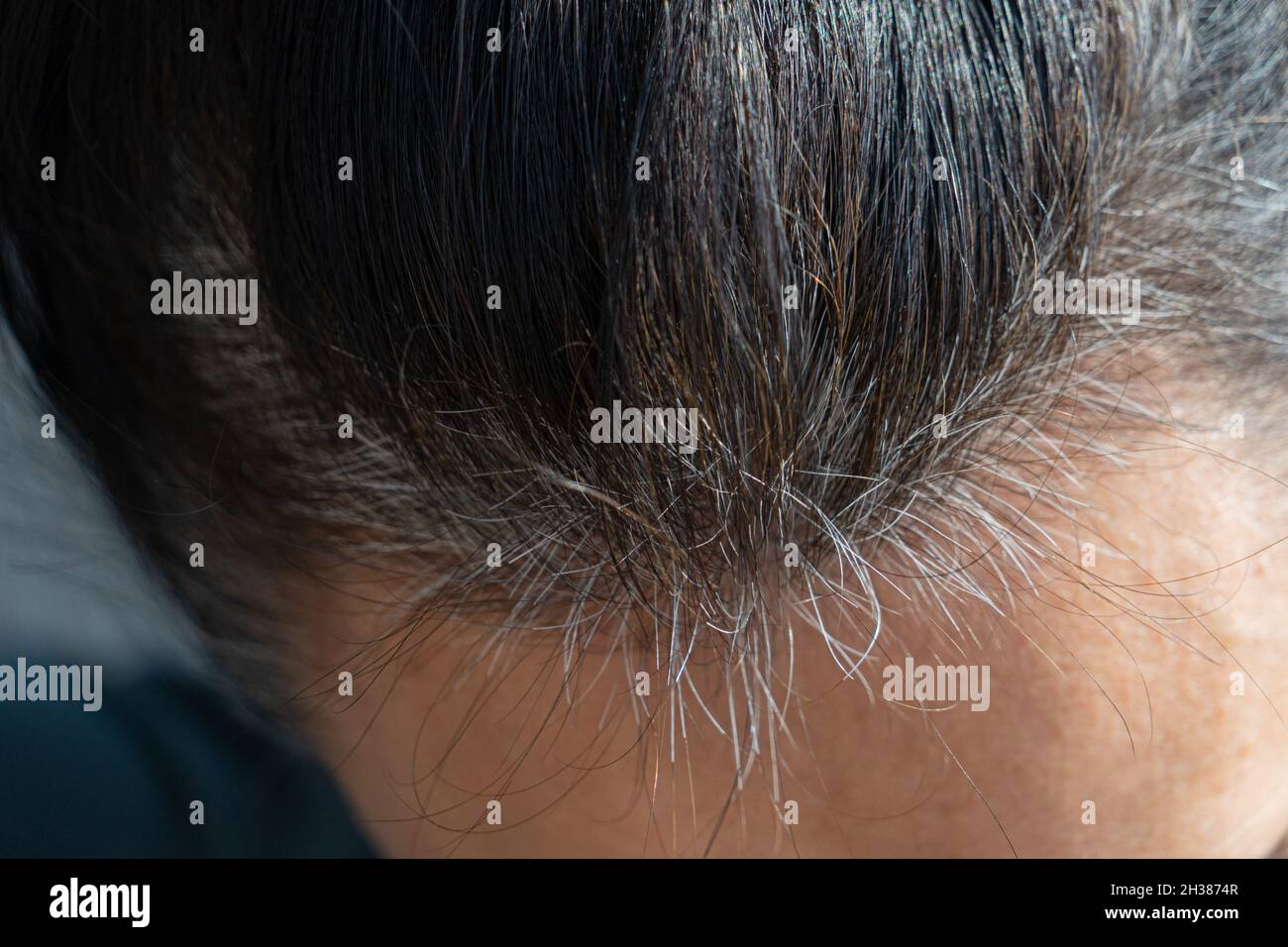 Close up of middle age caucasian woman with dark brown hair and regrown ...