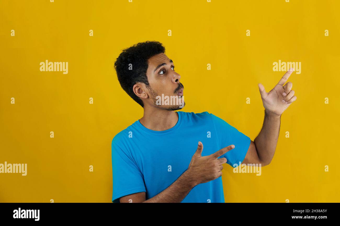 Man pointing finger isolated on yellow background. Handsome Black Man ...