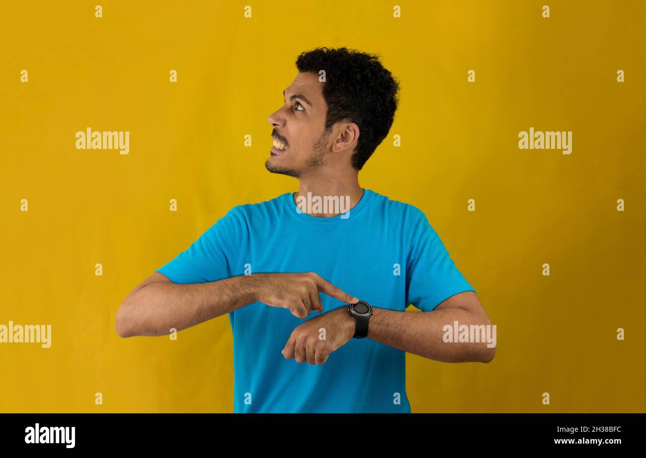 Adult man pointing at his watch on his wrist. Handsome Black Man with ...