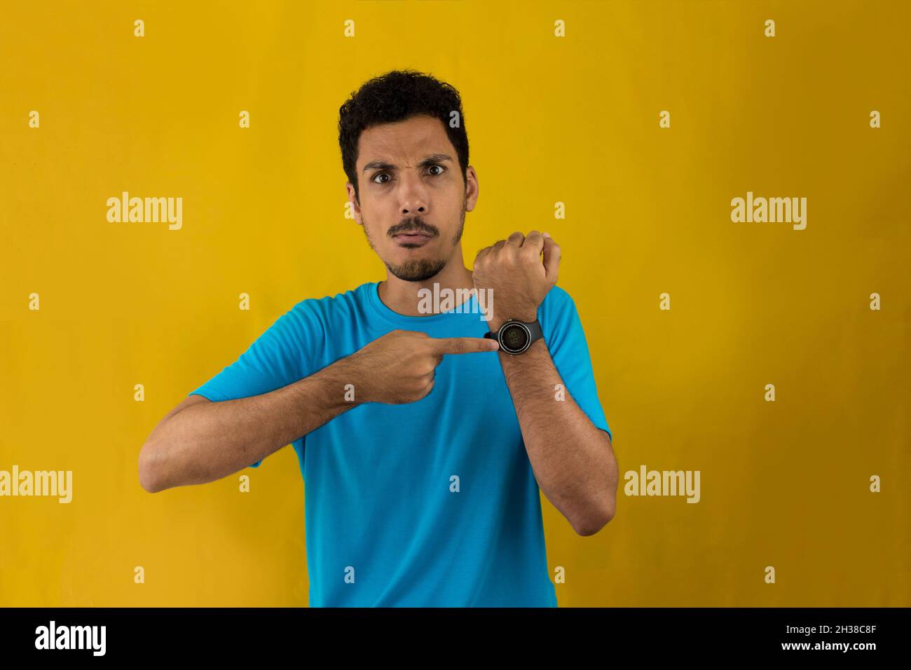 Adult man pointing at his watch on his wrist. Handsome Black Man with ...