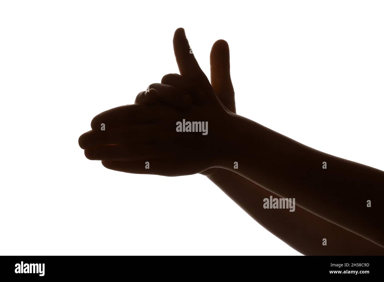 Child performing a shadow play on white background Stock Photo - Alamy