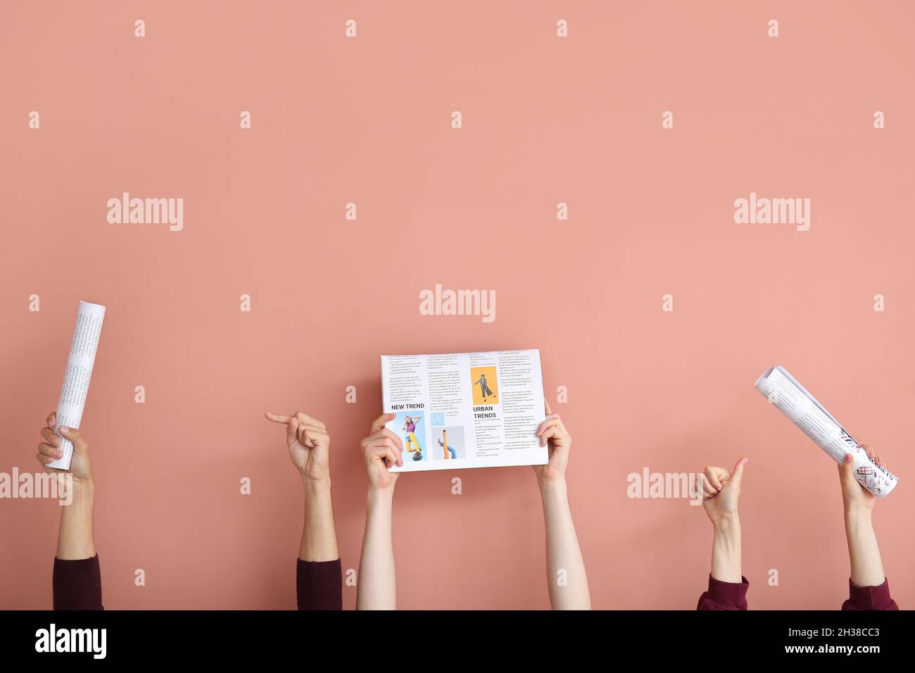 People with newspapers on pink background Stock Photo - Alamy