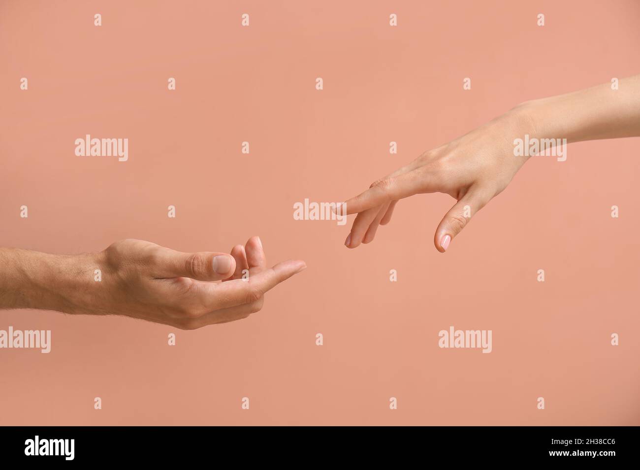 Woman and man reaching out to each other on beige background Stock ...