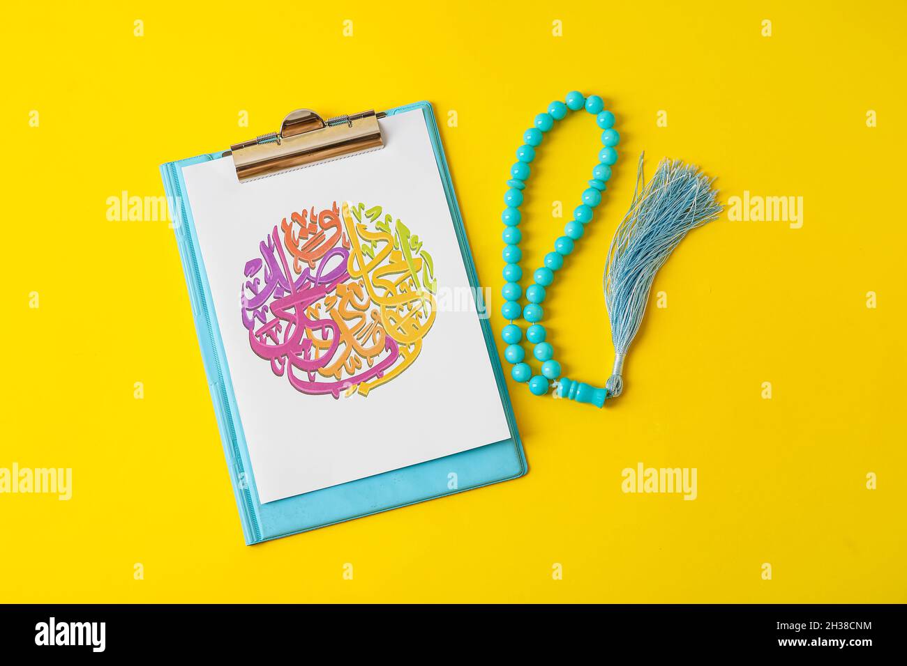 Paper with Arabic text and tasbih on color background Stock Photo - Alamy