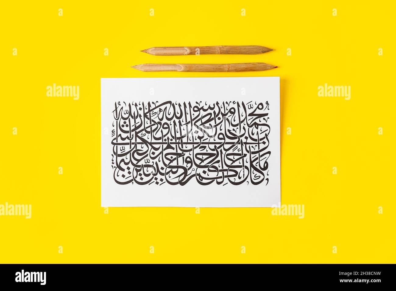 Paper with Arabic text and dip pens on color background Stock Photo - Alamy