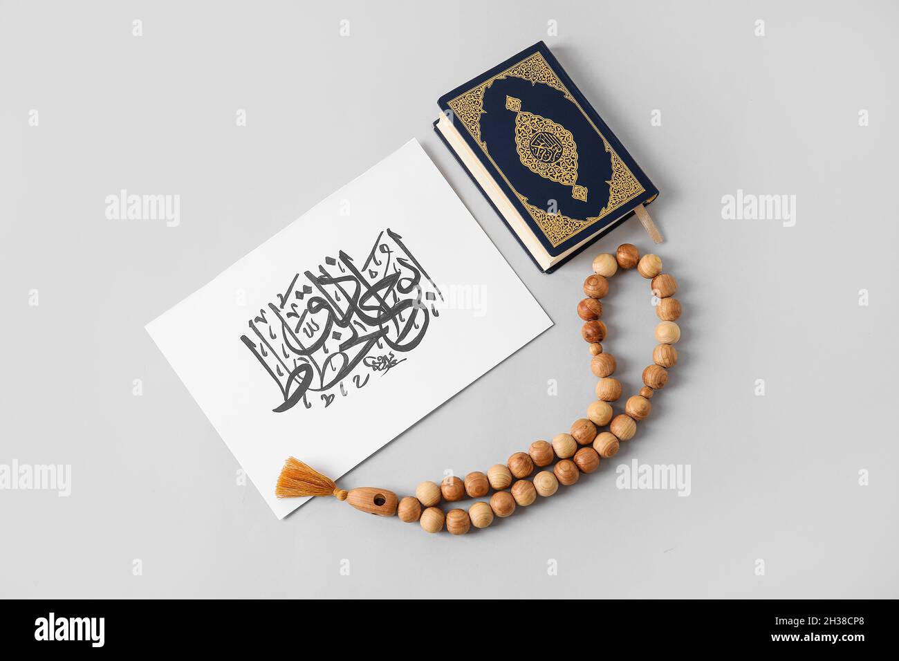 Paper with Arabic text, Koran and tasbih on light background Stock ...