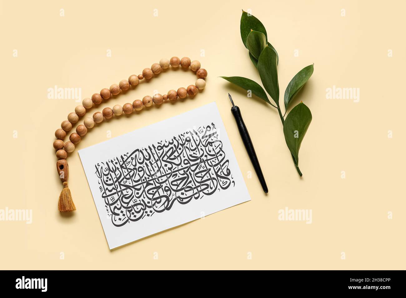 Paper with Arabic text, pen and tasbih on color background Stock Photo ...