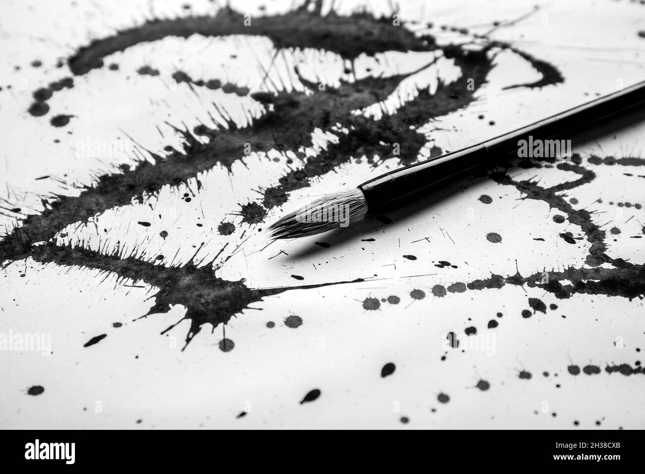 Ink spots and brush for calligraphy on white paper Stock Photo - Alamy