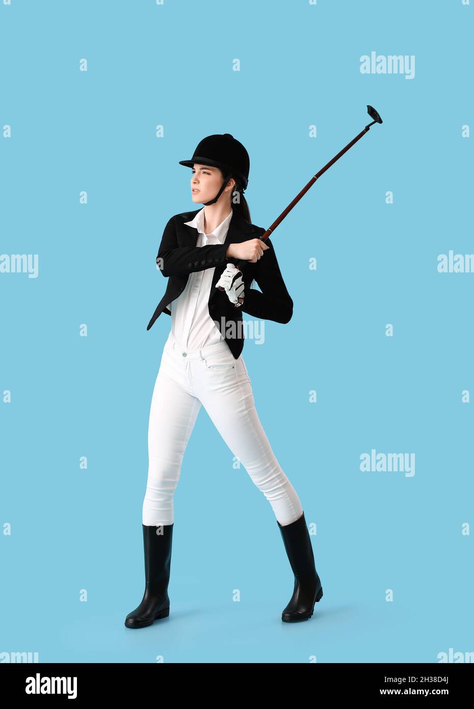 Beautiful female polo player on color background Stock Photo - Alamy