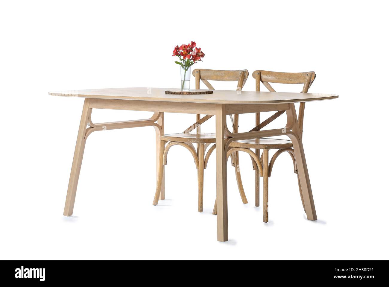 Wooden dining table with flowers and chairs on white background Stock ...