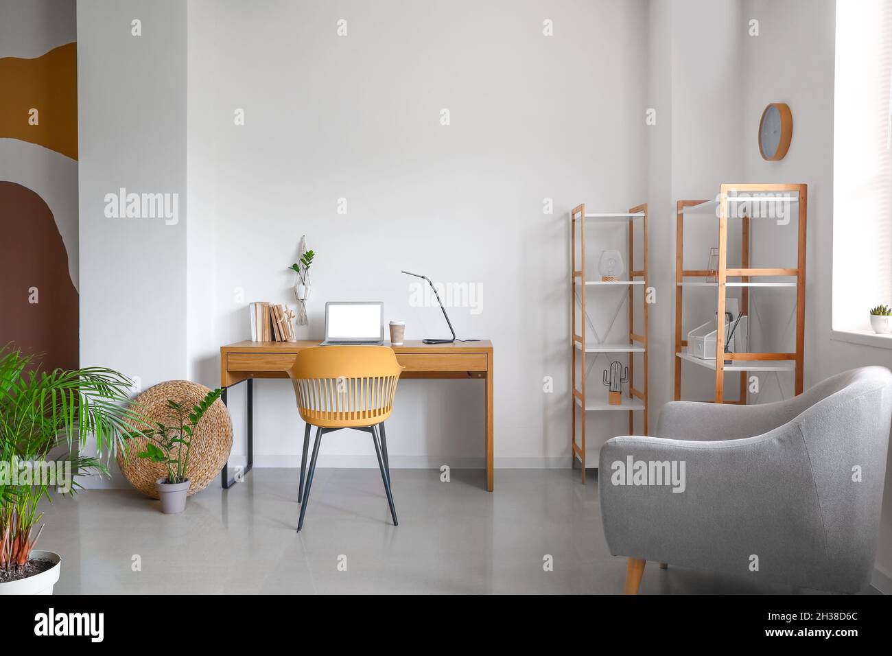 Interior of room with comfortable workspace, shelves and armchair Stock ...