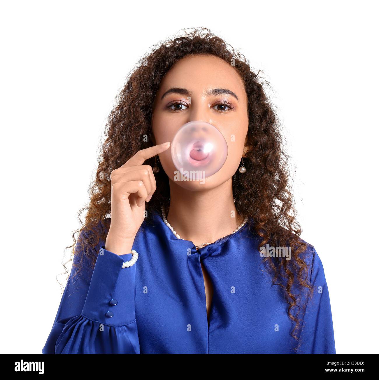 African-American woman with chewing gum on white background Stock Photo ...
