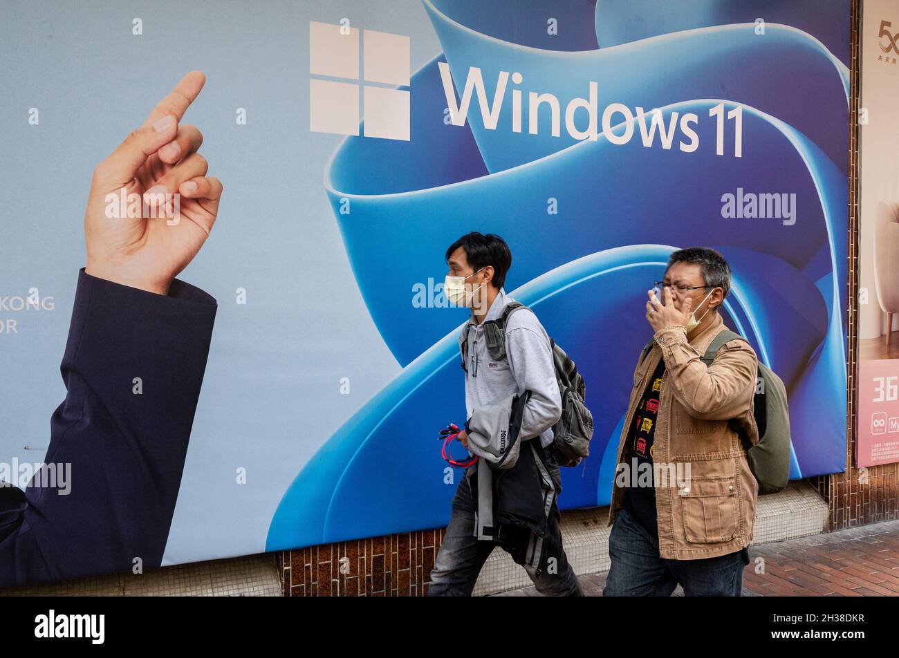Hong Kong, China. 26th Oct, 2021. Pedestrians walk past a commercial ...