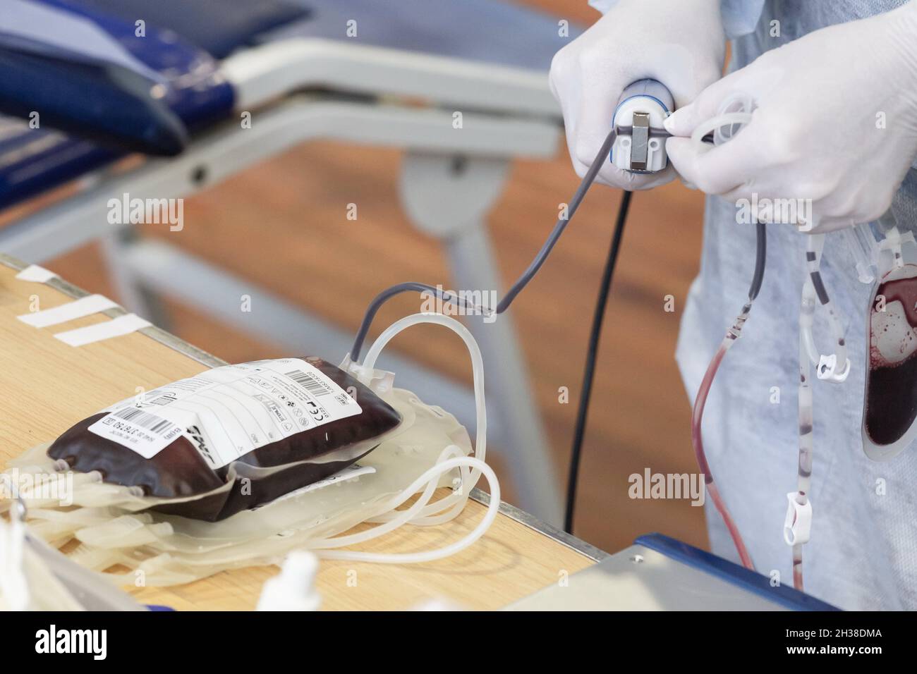 Reutov, Russia. 15th Apr, 2020. The doctor bites the tube from the bag ...