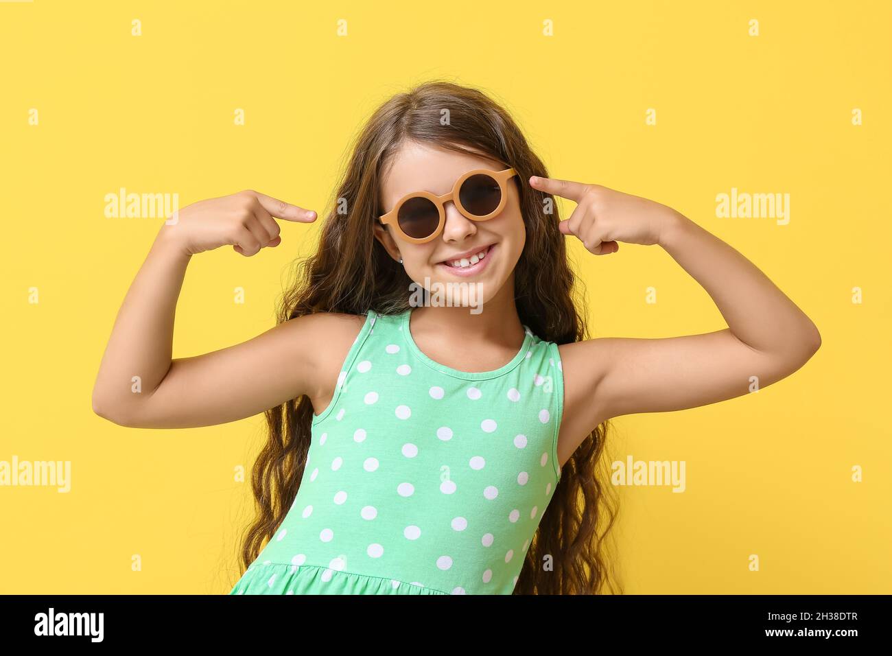 Cool stylish little girl on color background Stock Photo - Alamy