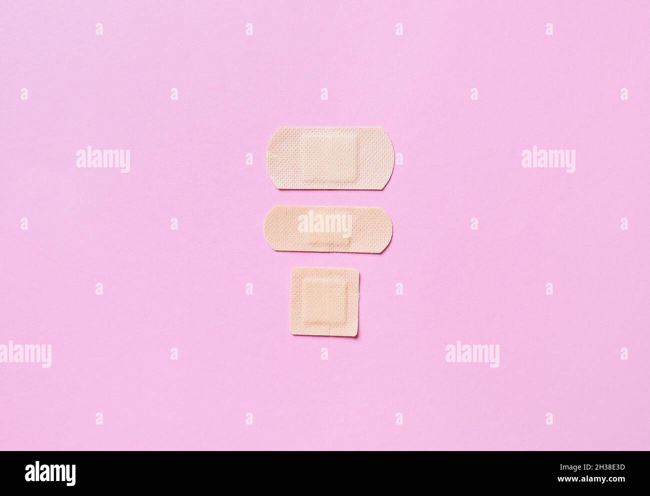 Different medical plasters on pink background Stock Photo - Alamy