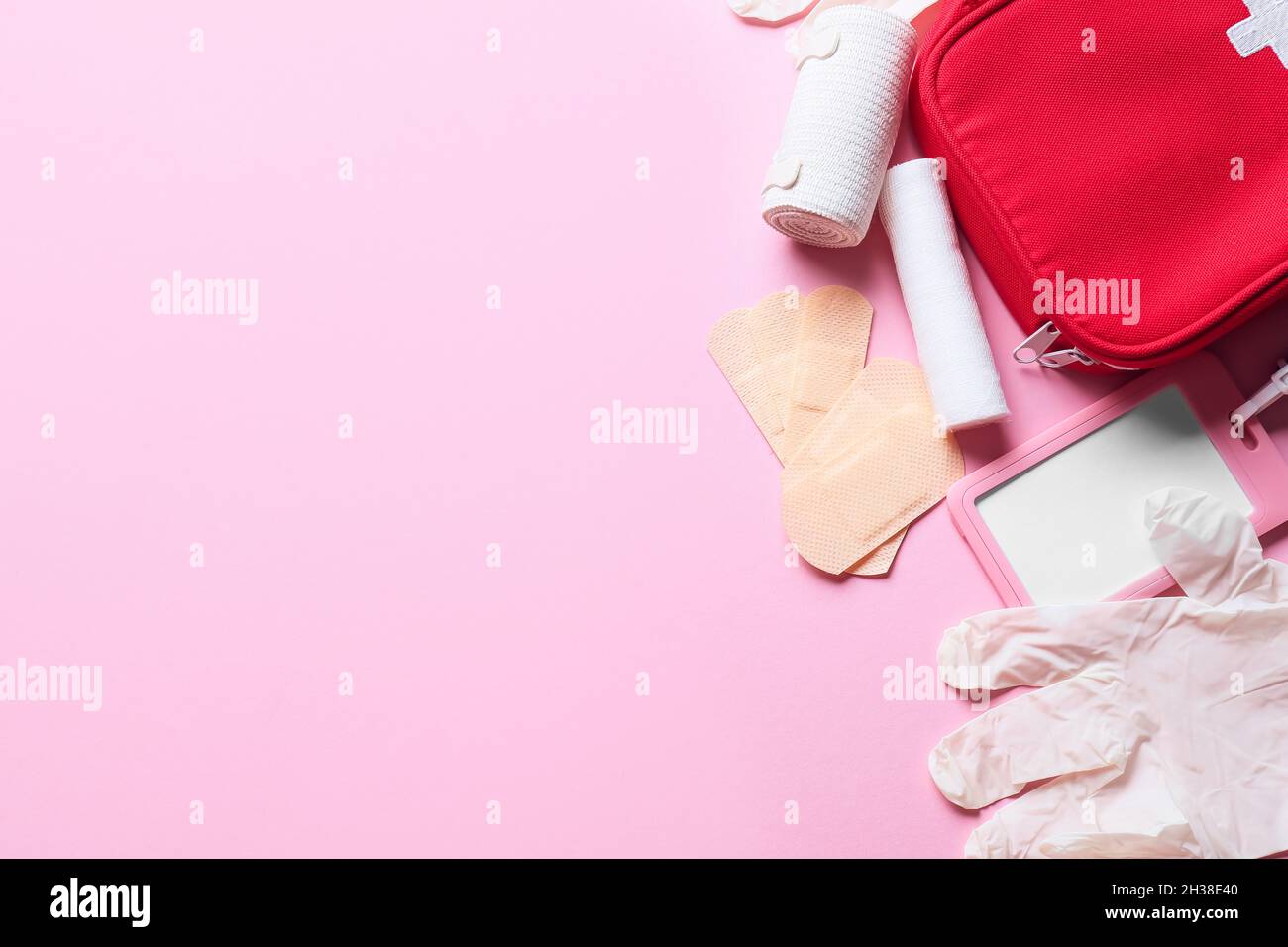 First aid kit and blank identification badge on color background Stock ...