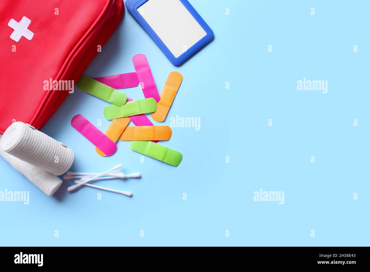 First aid kit and blank identification badge on blue background Stock ...