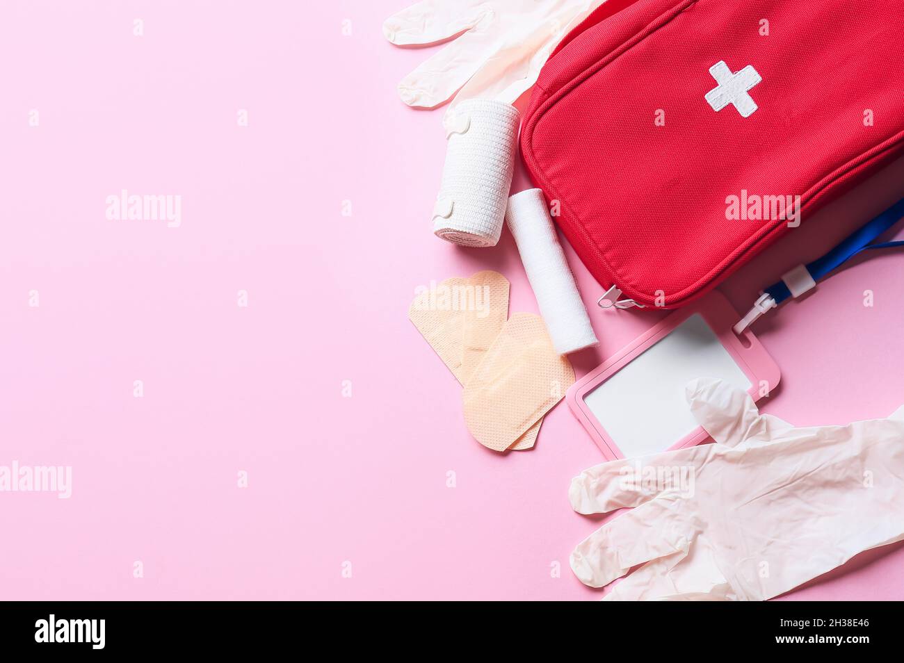 First aid kit and blank identification badge on color background Stock ...