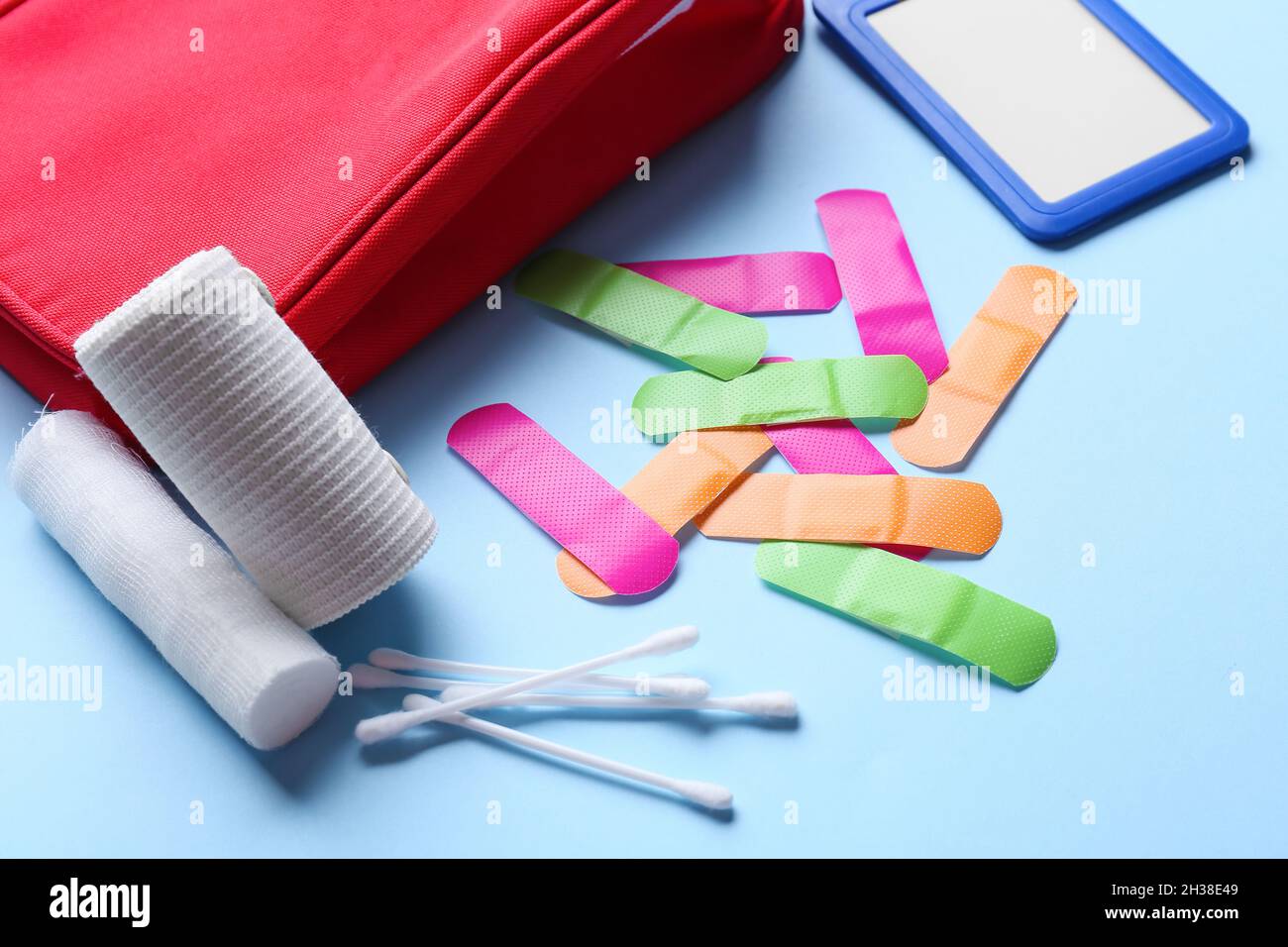 First aid kit and blank identification badge on blue background ...