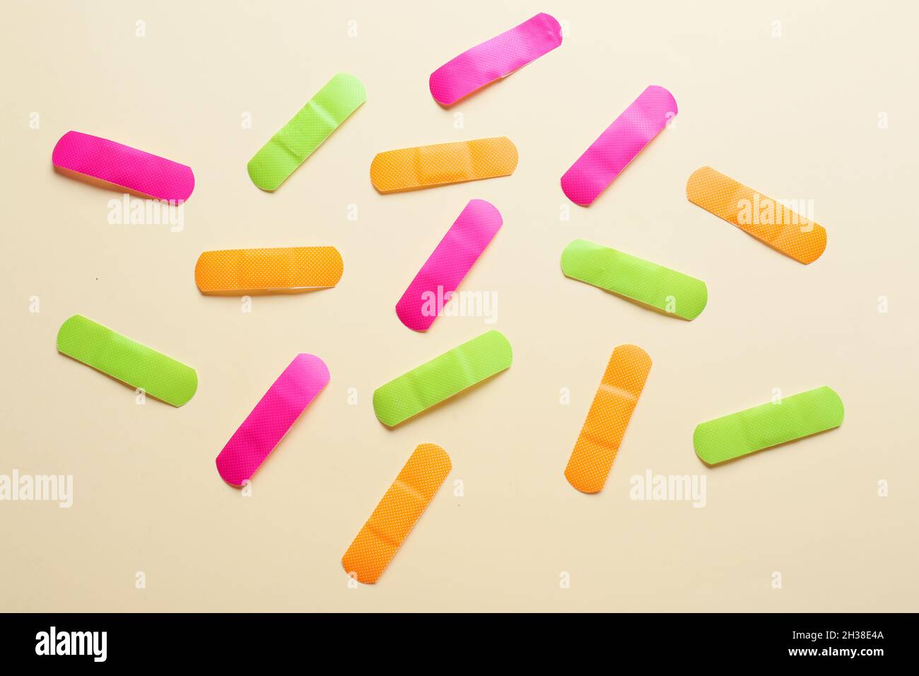 Different medical plasters on color background Stock Photo - Alamy