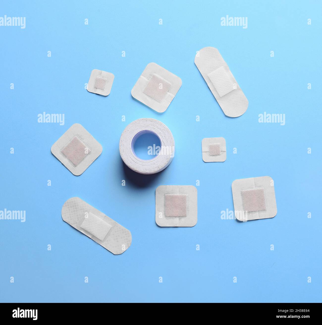 Different elastic medical plasters on blue background Stock Photo - Alamy